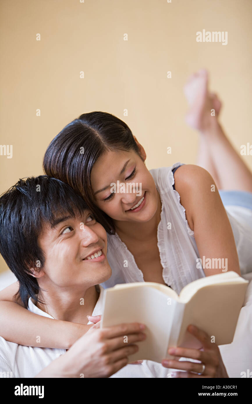 Couple reading book together Stock Photo - Alamy