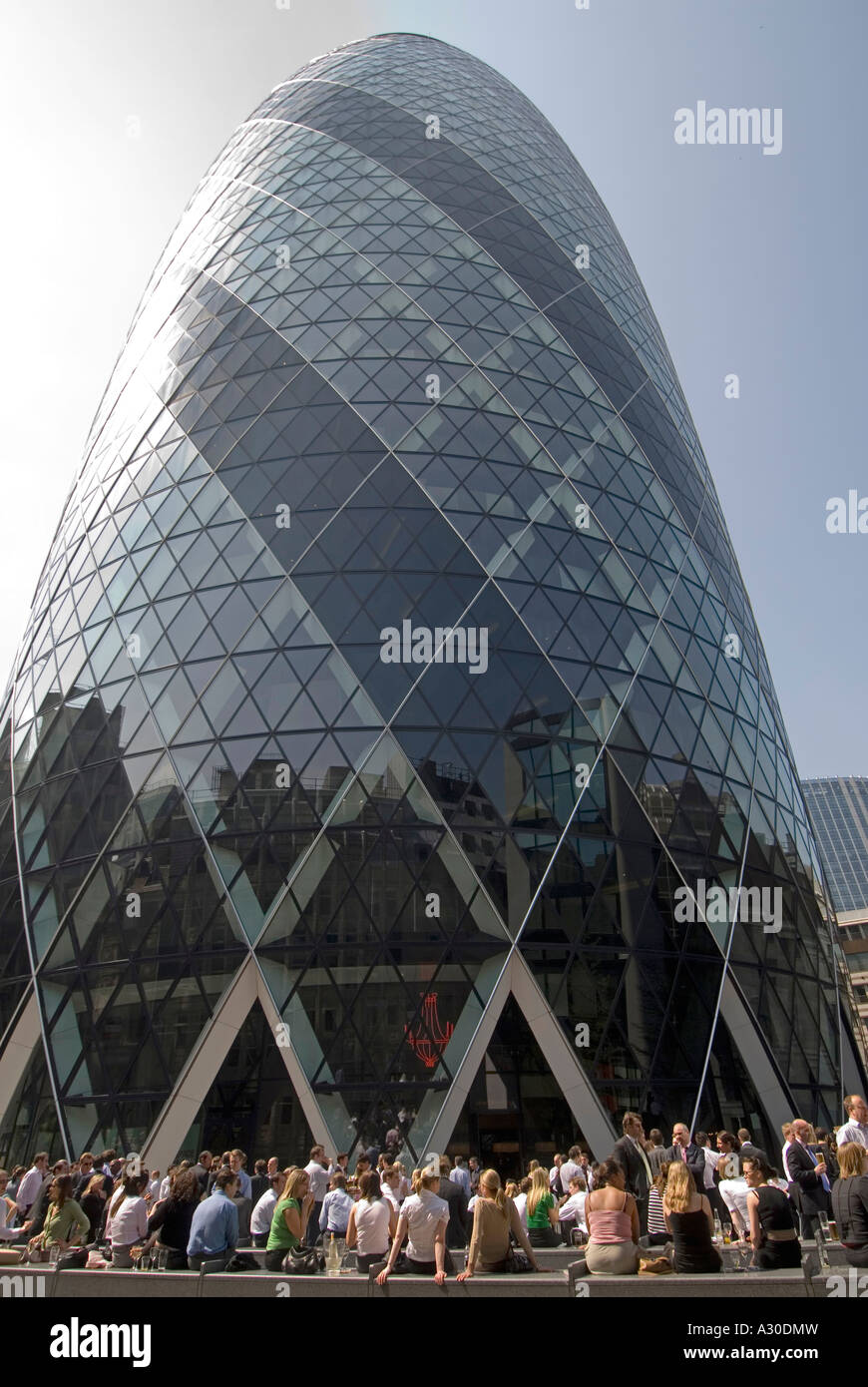 City of London close up of Gherkin building with office workers ...