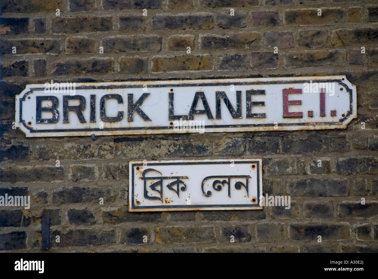 Multilingual street signs fixed to traditional old London Stock brick ...