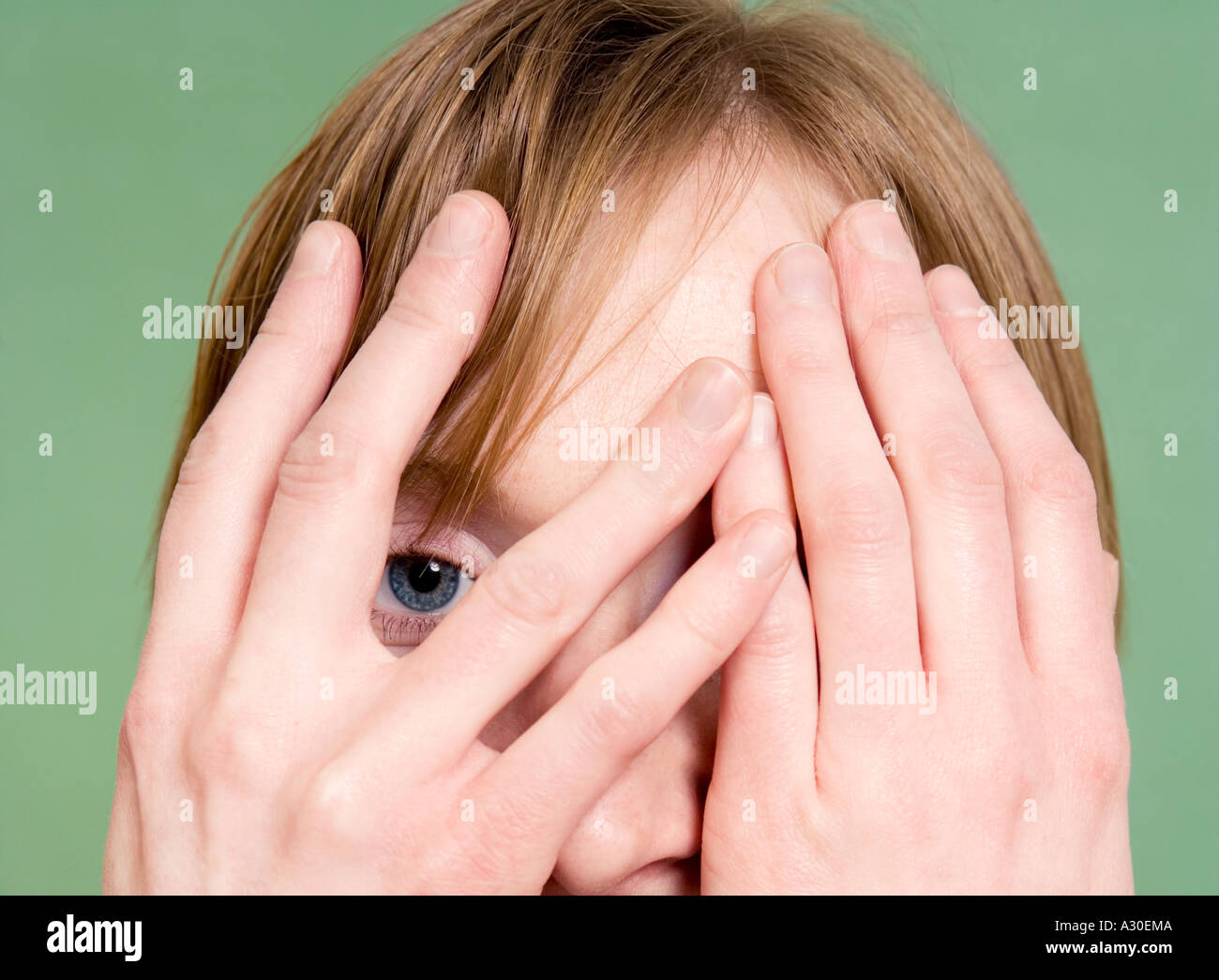 Young woman with hands over face, close up Stock Photo - Alamy