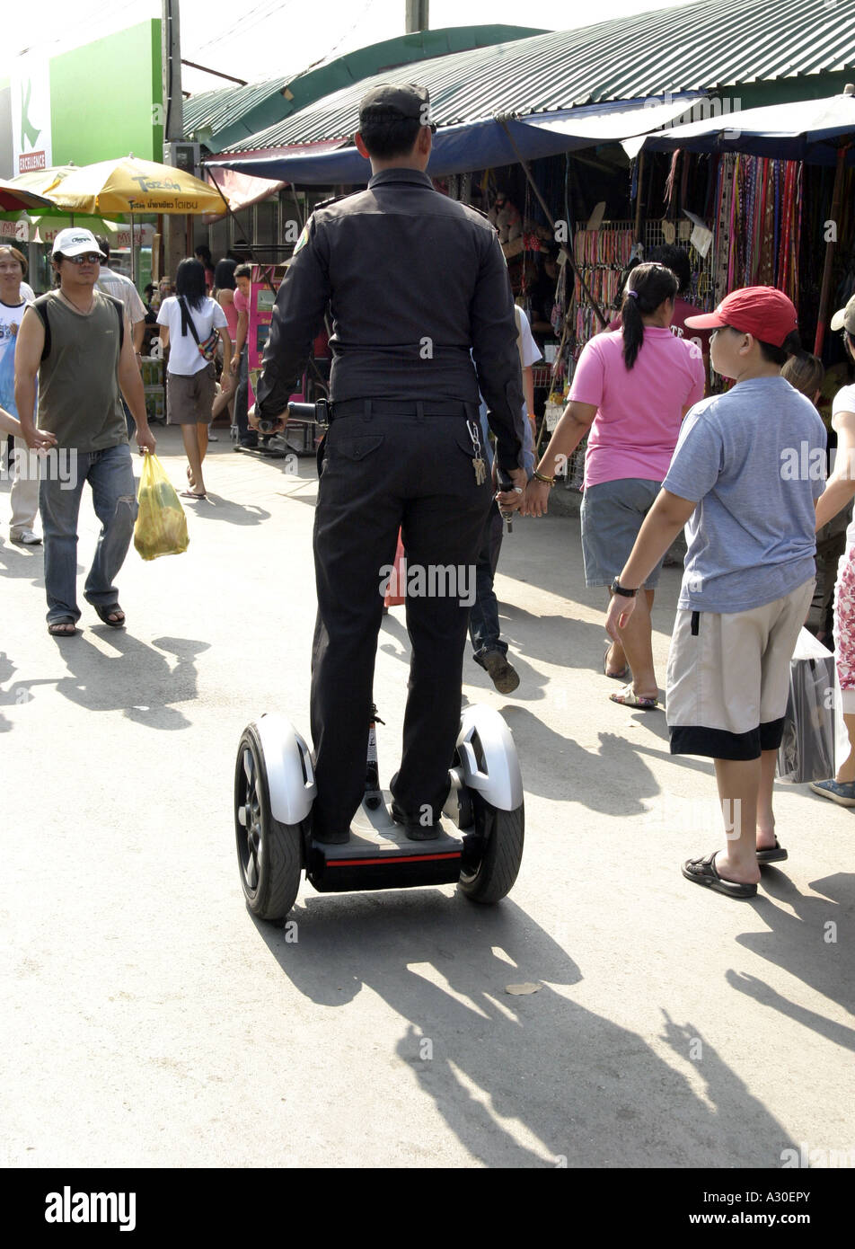 Security guard on a unicycle at The Chatuchak Weekend Market Bangkok ...