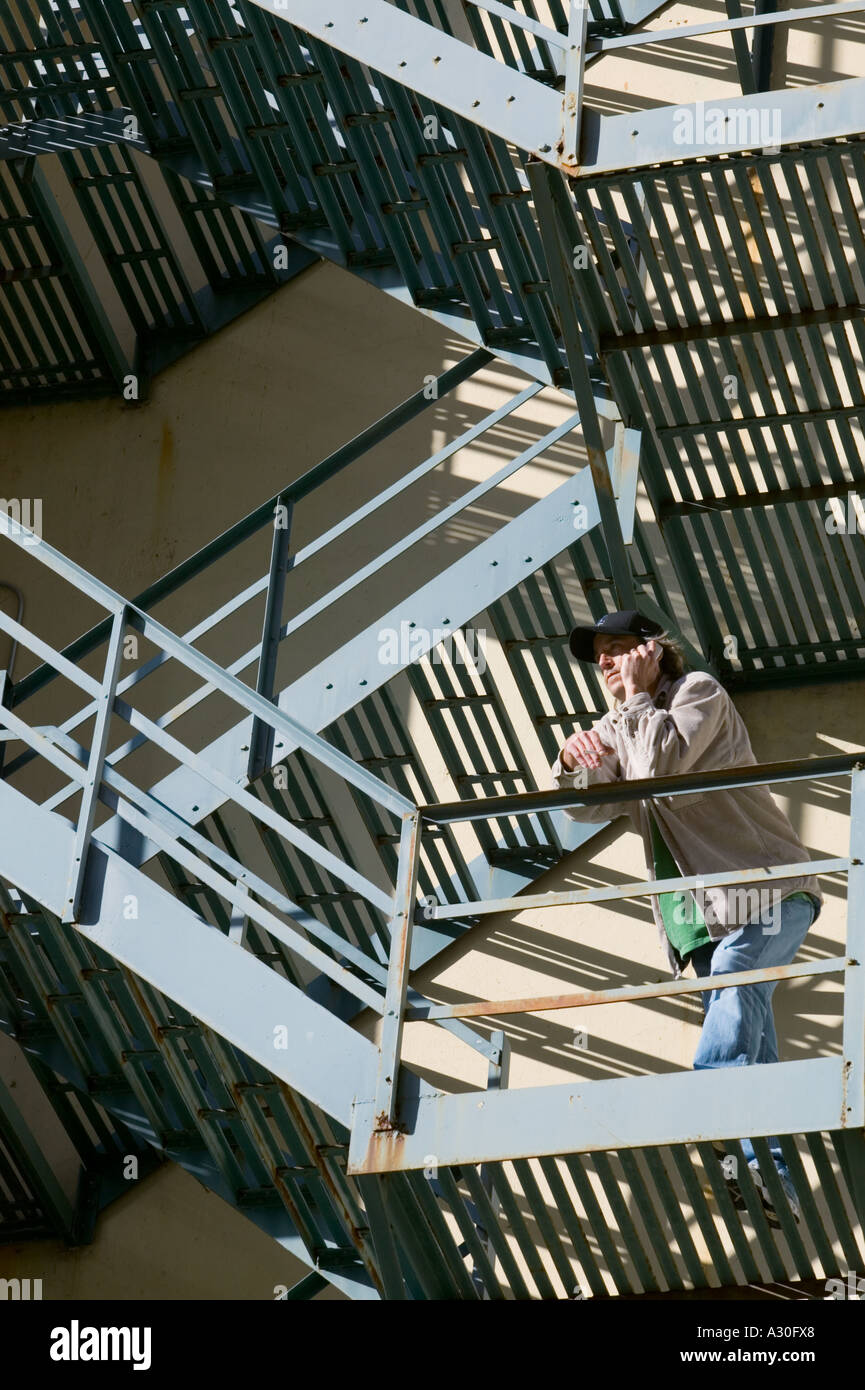 Man smoking on fire escape hi-res stock photography and images - Alamy