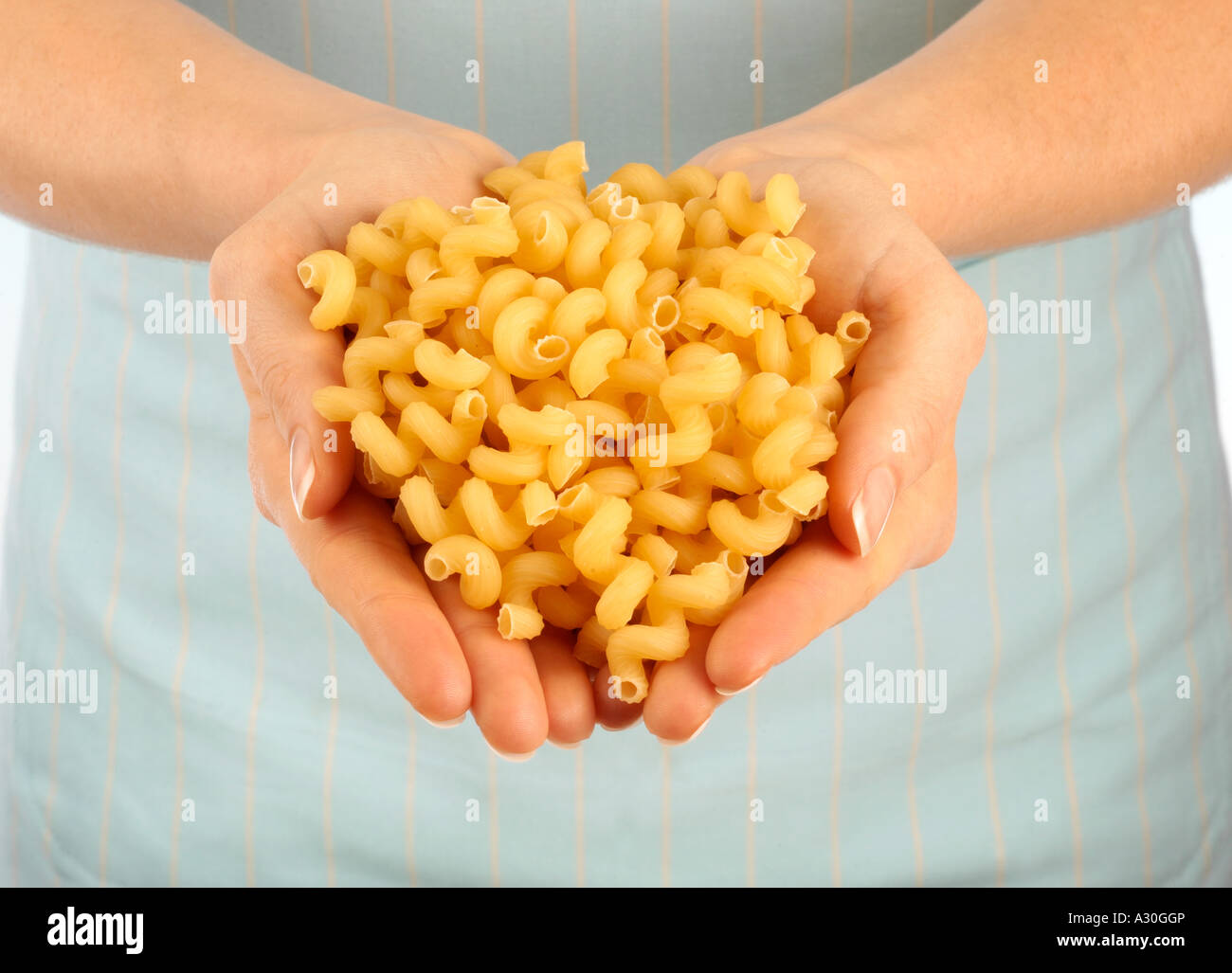 WOMAN WITH HANDFUL OF CURLY PASTA Stock Photo - Alamy