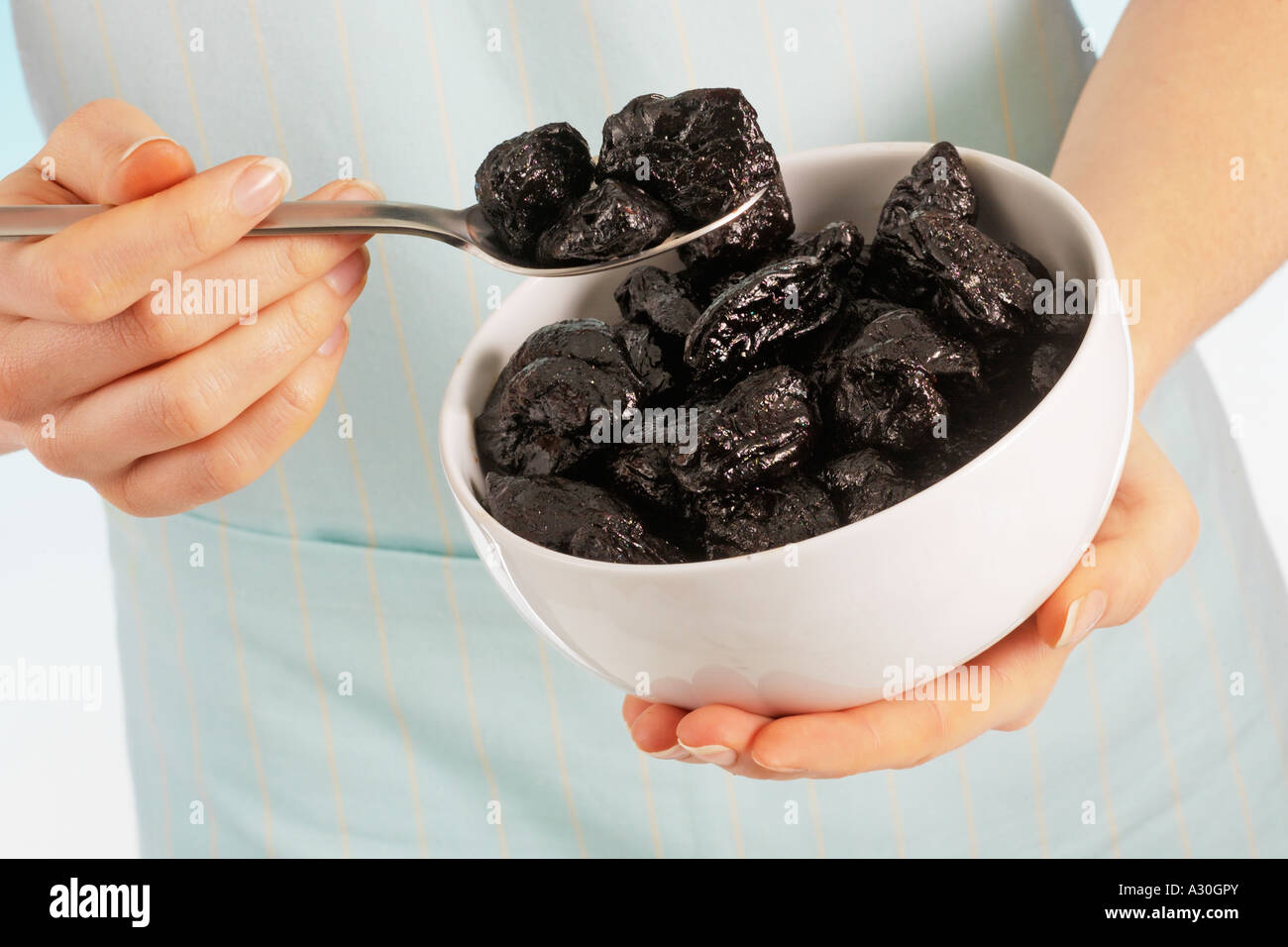 WOMAN EATING PRUNES Stock Photo - Alamy