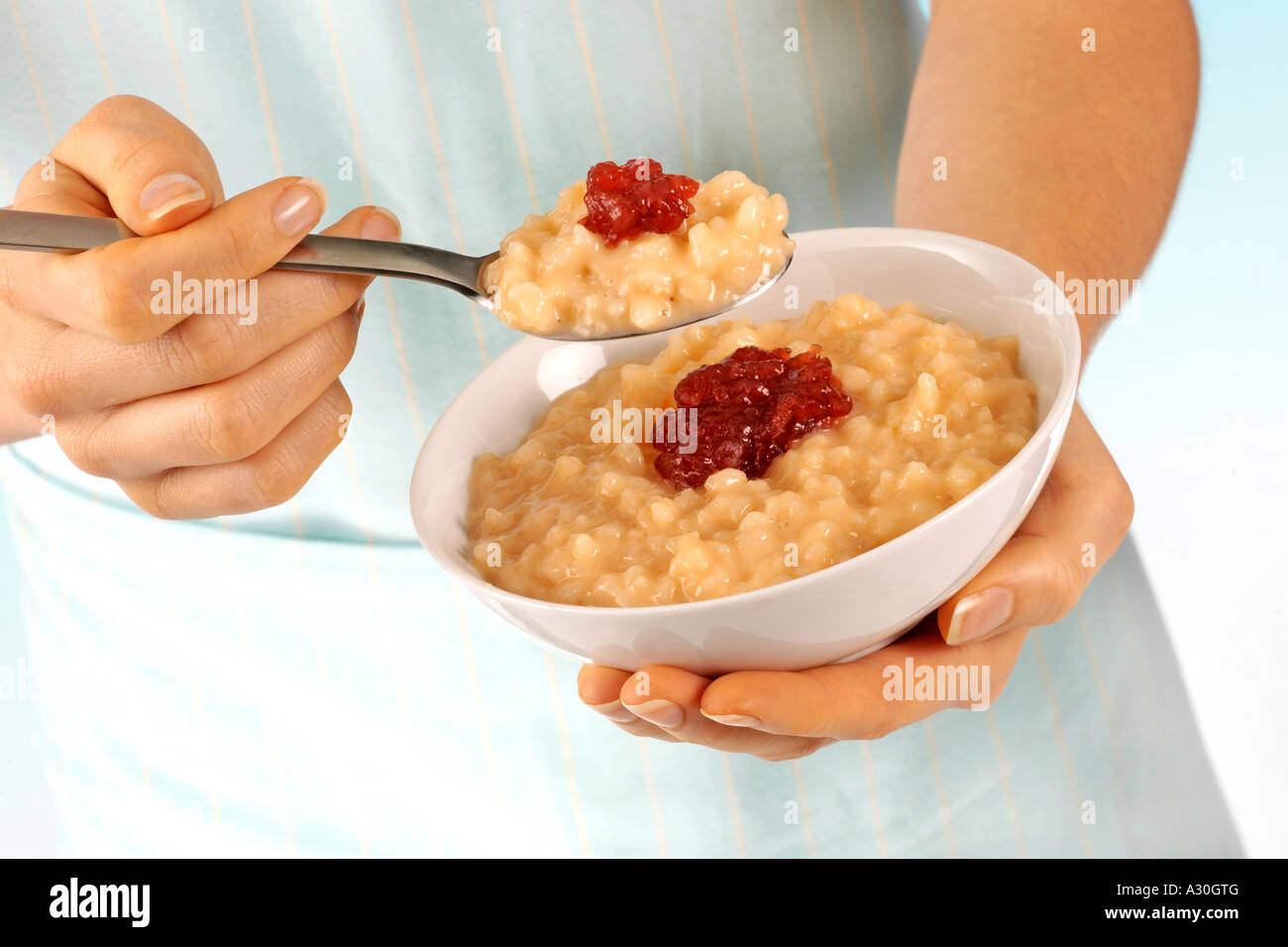 WOMAN EATING RICE PUDDING Stock Photo - Alamy