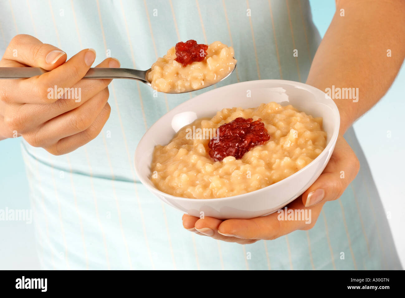 WOMAN EATING RICE PUDDING Stock Photo - Alamy