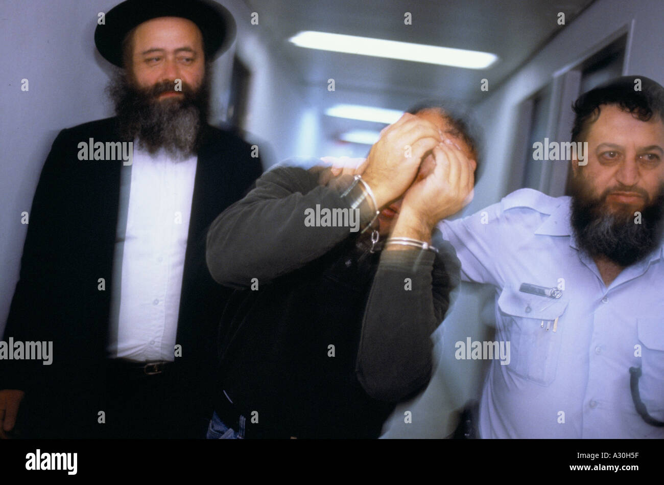 An absentee husband covers his face as he is arrested by Rabbi ...