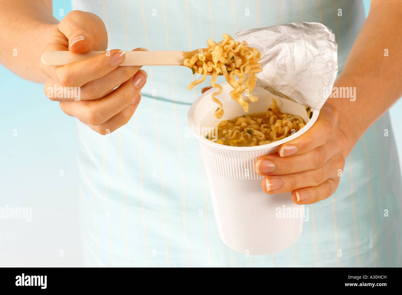 WOMAN EATING POT NOODLE Stock Photo - Alamy