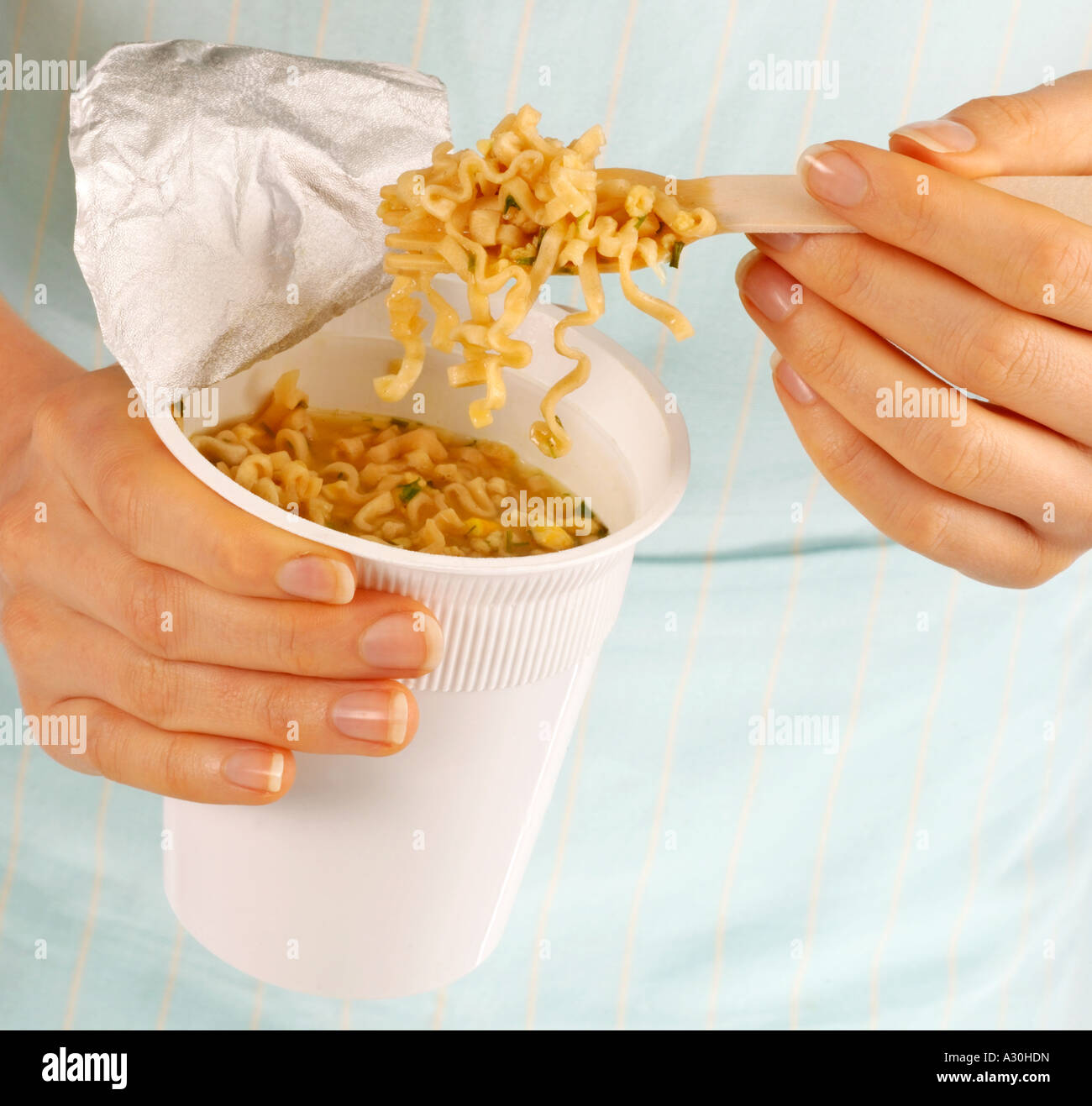 WOMAN EATING POT NOODLE Stock Photo - Alamy