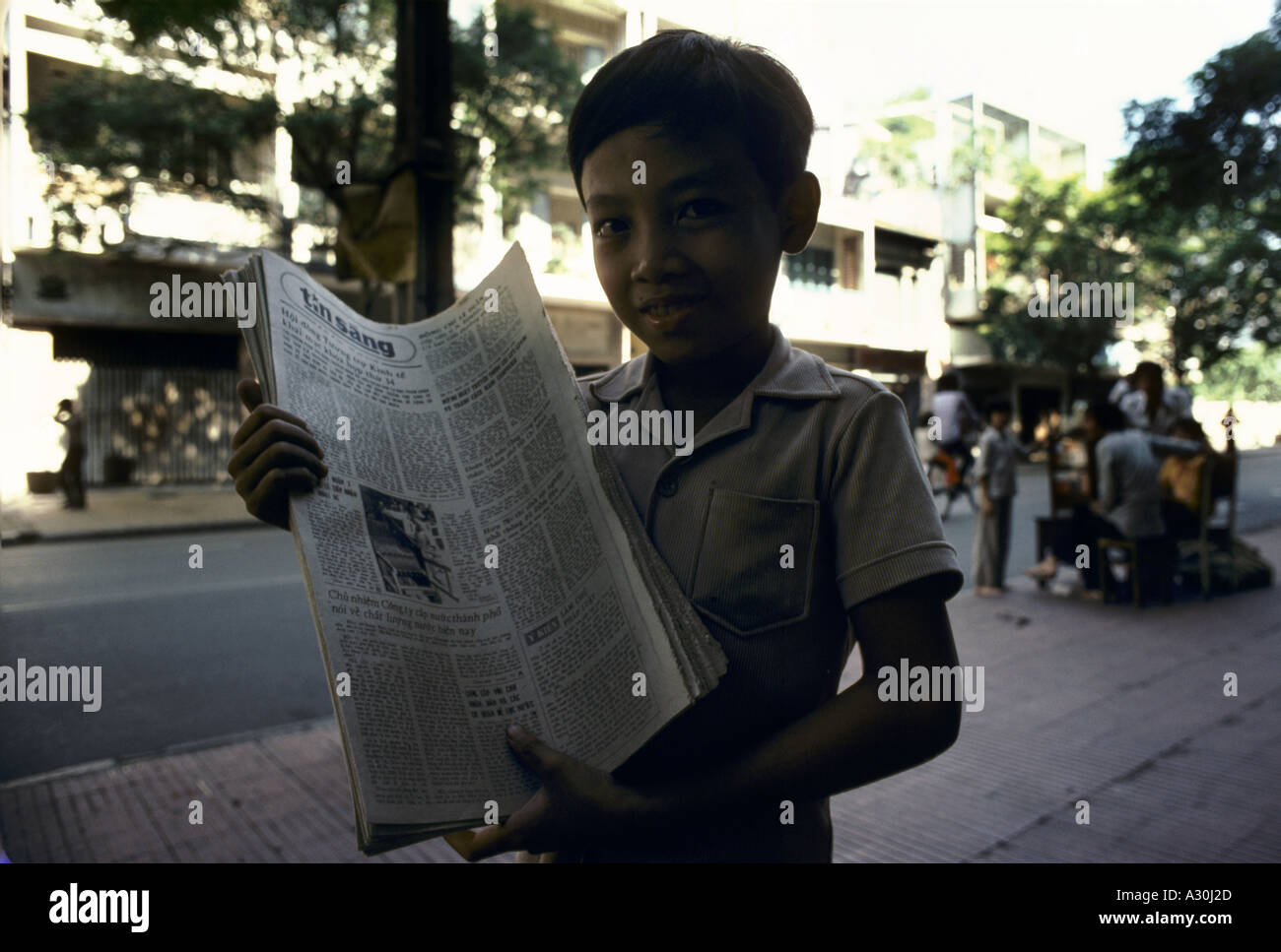 child with newspapers vietnam Stock Photo - Alamy