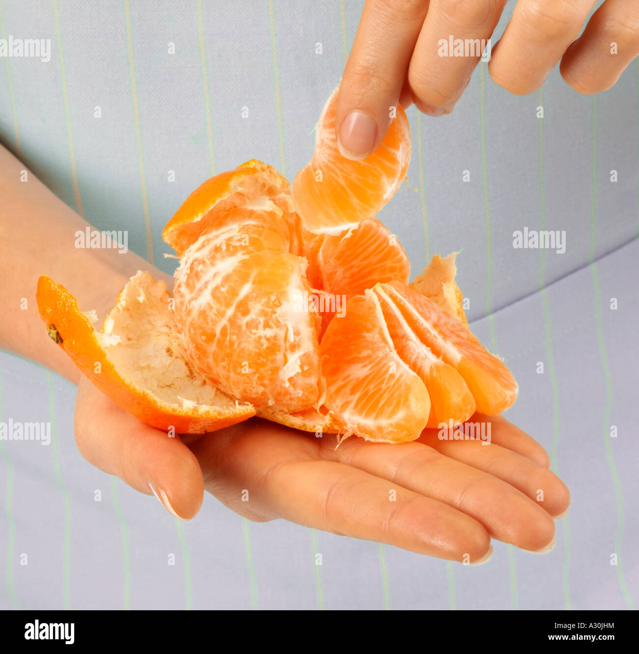 Womans hands peeling tangerine hi-res stock photography and images - Alamy