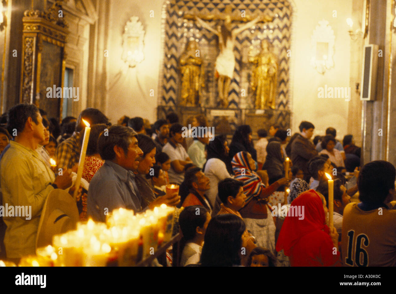 mexico guadalupe shrine people praying with candle lit Stock Photo - Alamy