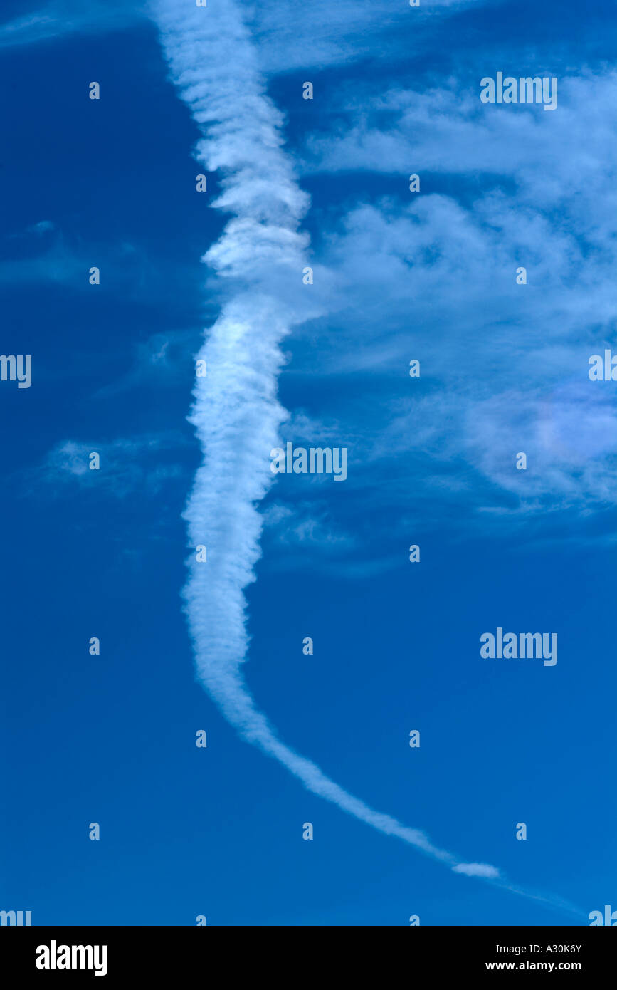 Developing cloud from fading jet airplane contrail Stock Photo - Alamy