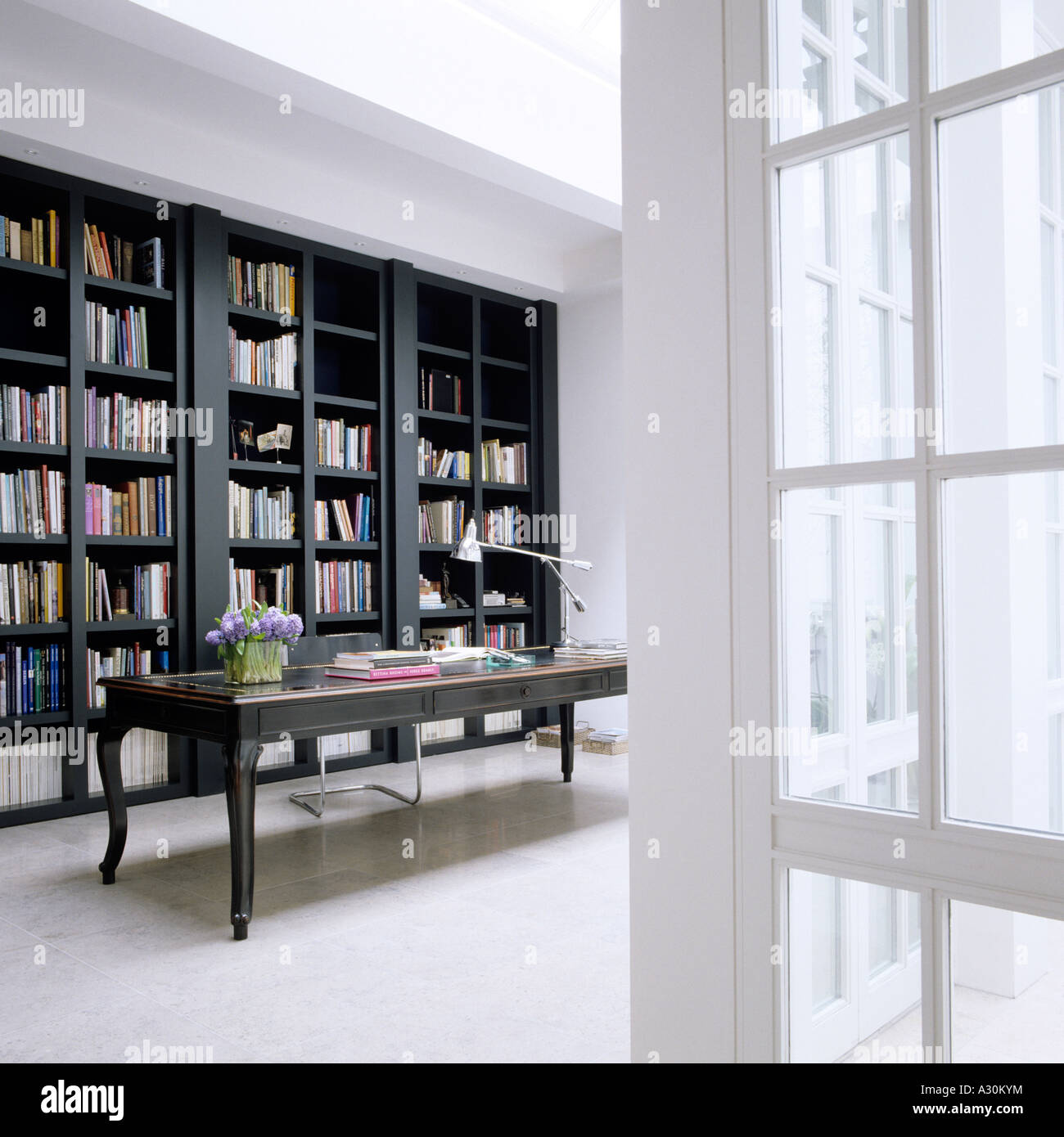 Bookcase in study of London townhouse Stock Photo - Alamy
