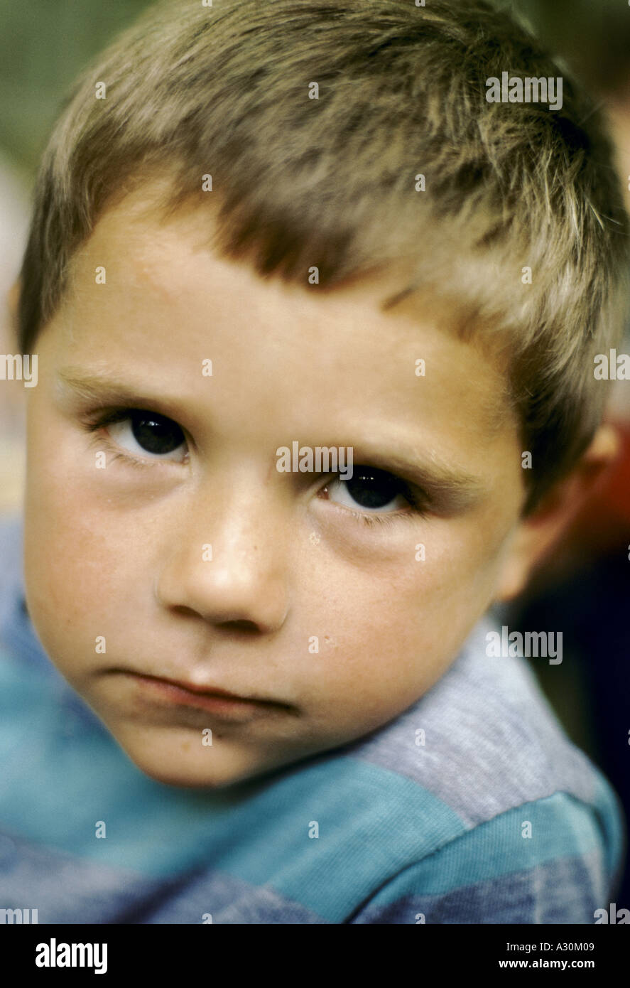 young boy with sullen expression Stock Photo - Alamy
