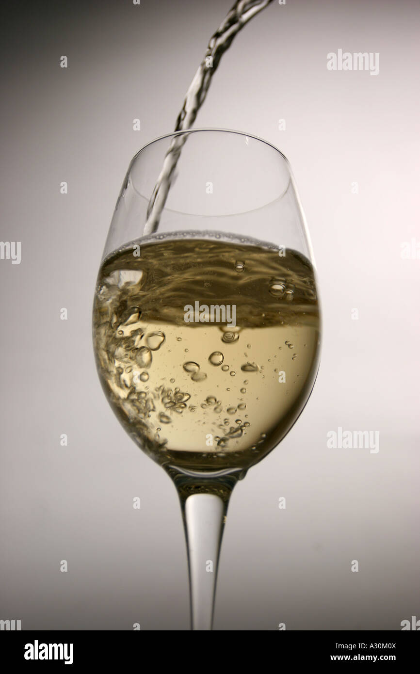 White wine pouring Stock Photo - Alamy