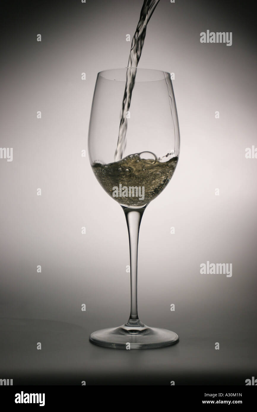 White wine pouring Stock Photo - Alamy