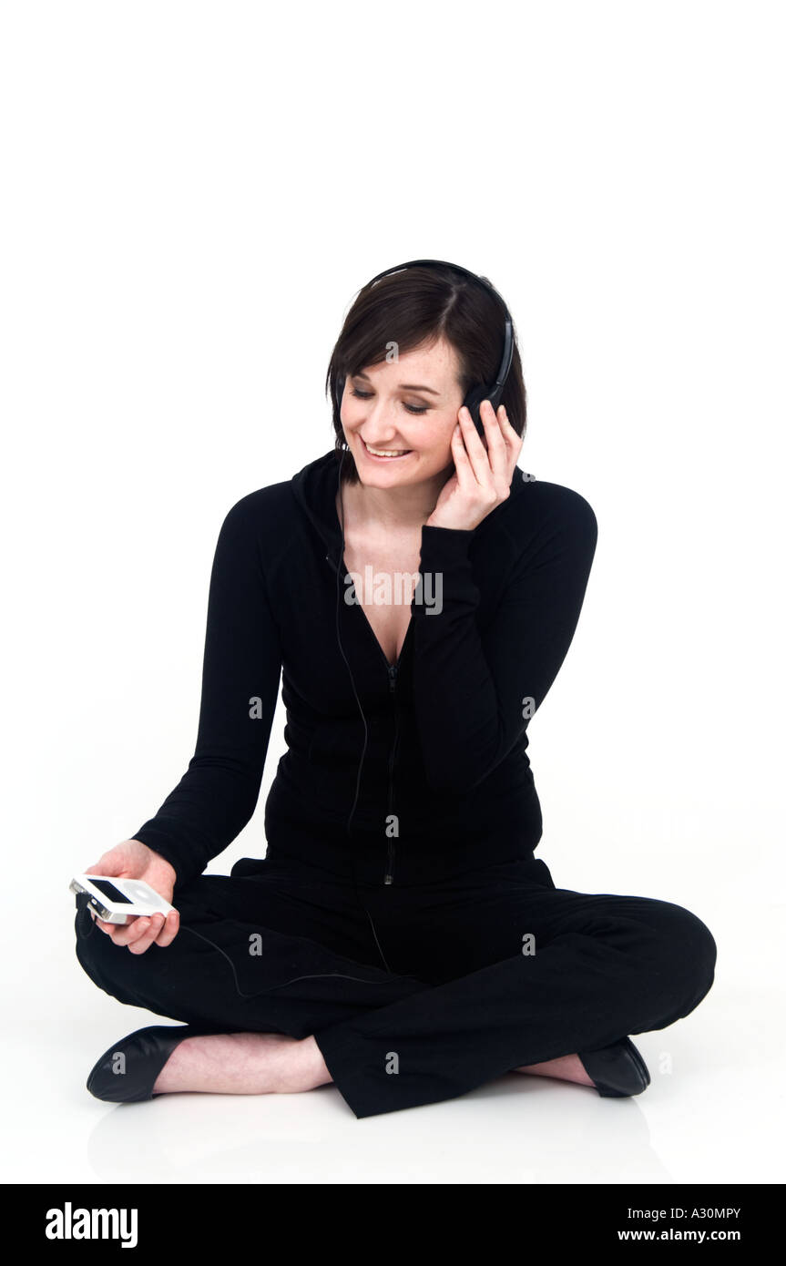 young woman listening to an ipod Stock Photo - Alamy