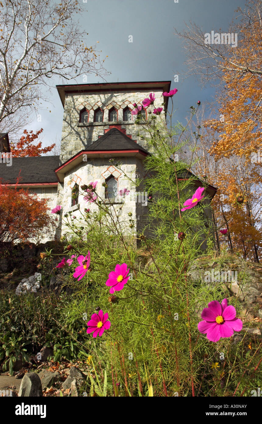 Pink flowers in front of a chapel in the grounds of the monastery ...
