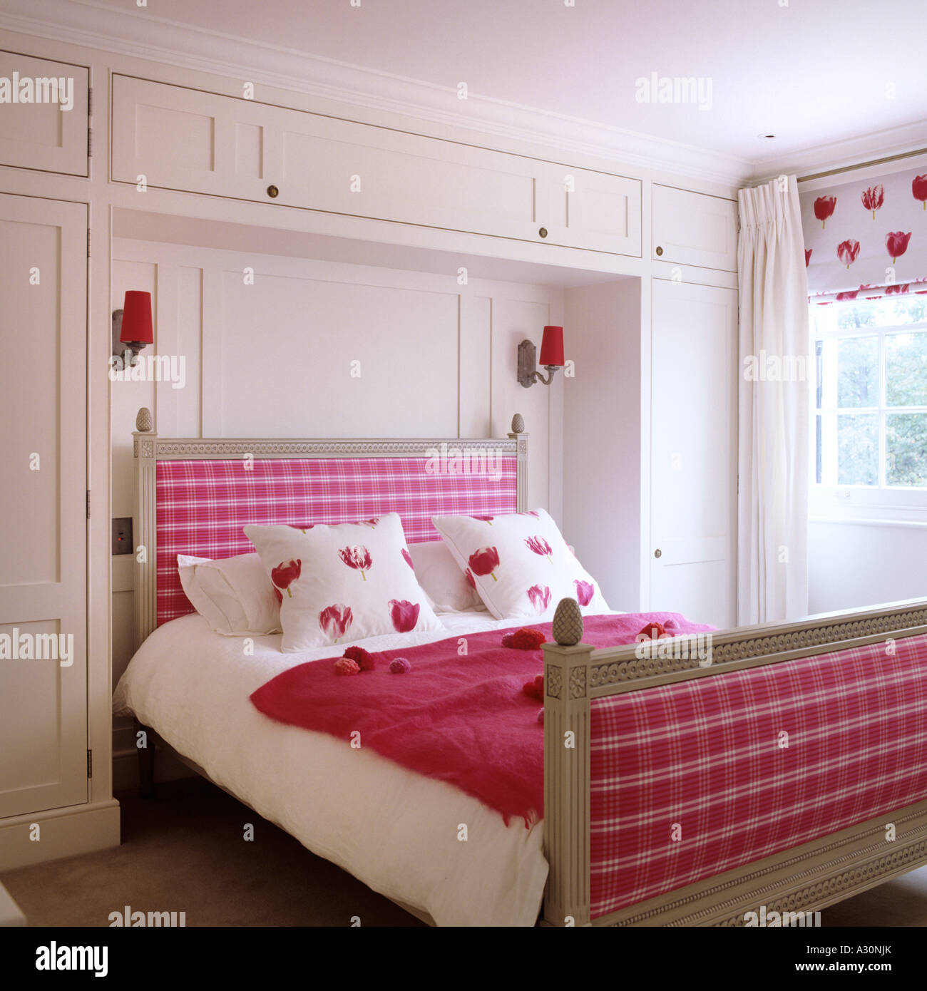 Recessed double bed with red checked headboard and tulip print cushions ...