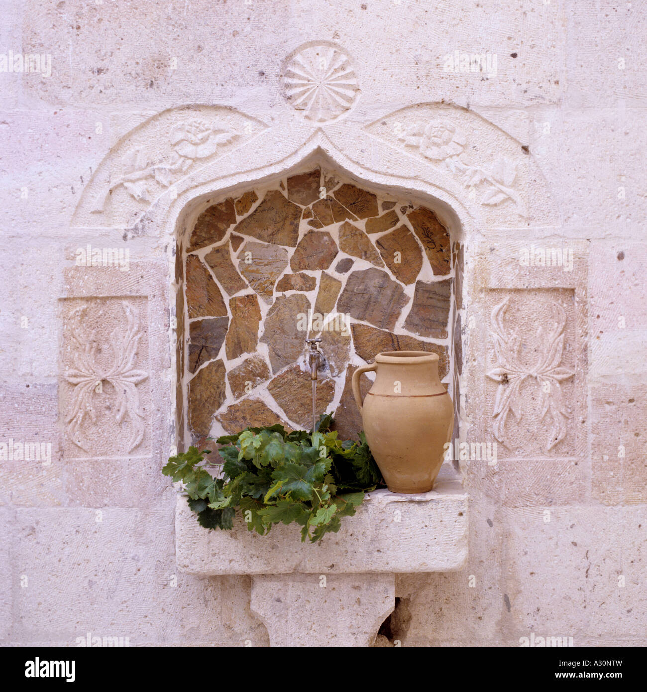 Arched and tiled sink with pottery urn Stock Photo - Alamy