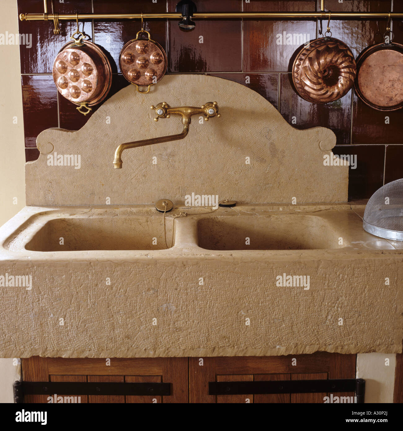 Stone double sink with brass jelly molds Stock Photo - Alamy