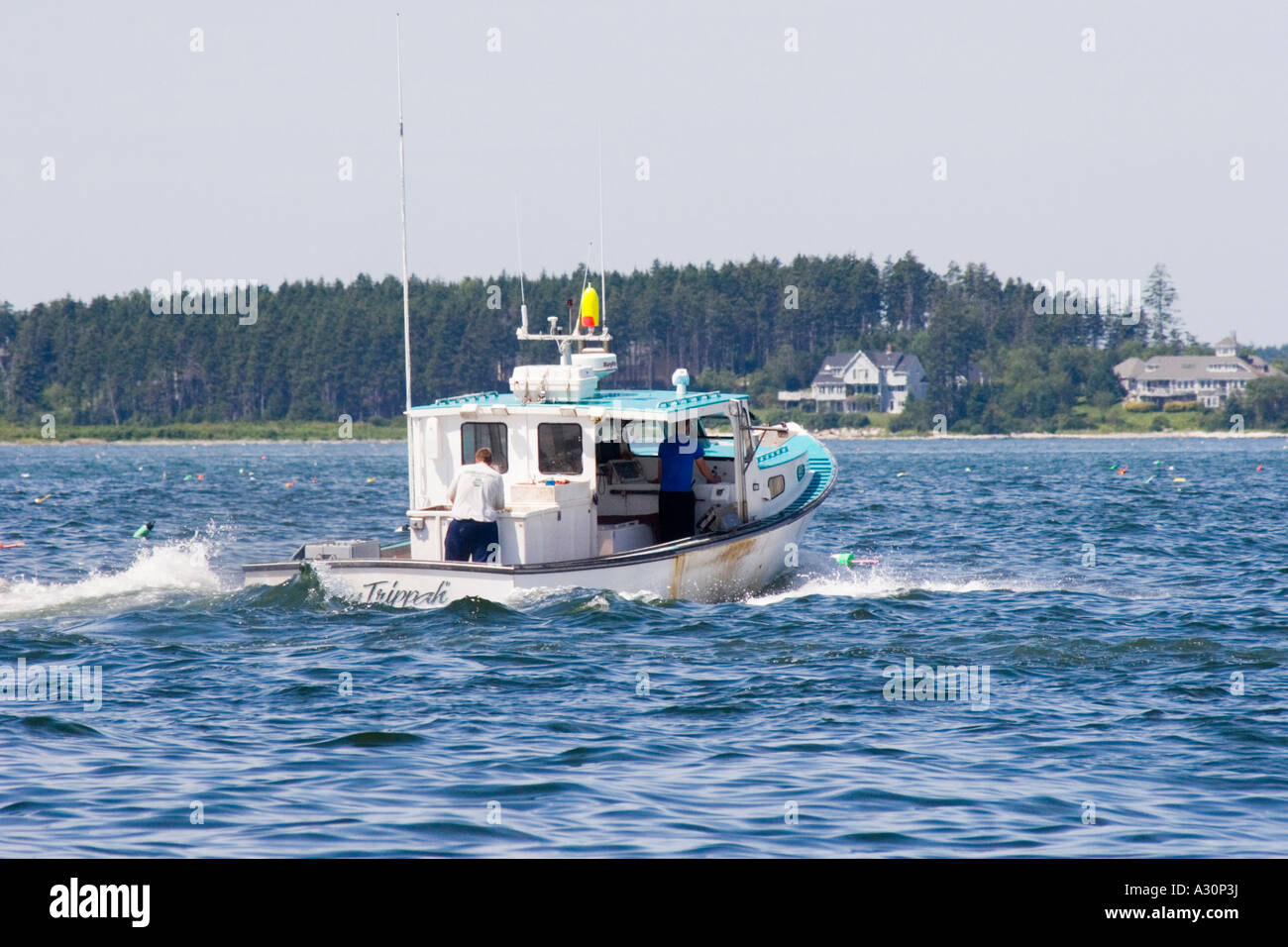 A lobster boat working the Muscle Ridge channel in Maine Stock Photo ...
