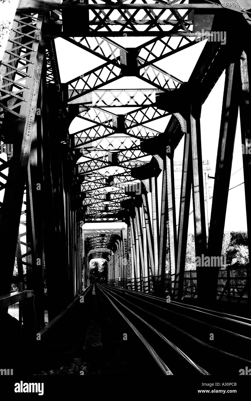 Distant train entering a railway bridge Stock Photo - Alamy