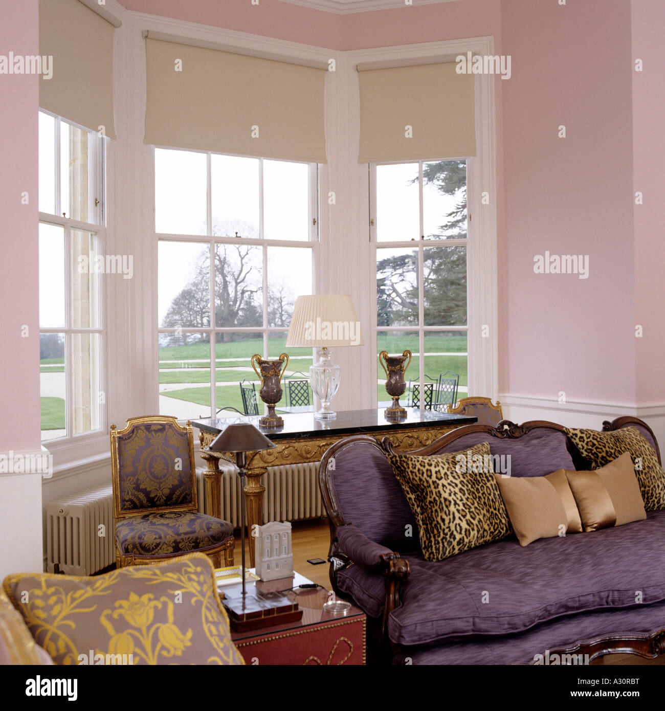 Bay window in pink living room with antique settee Stock Photo - Alamy