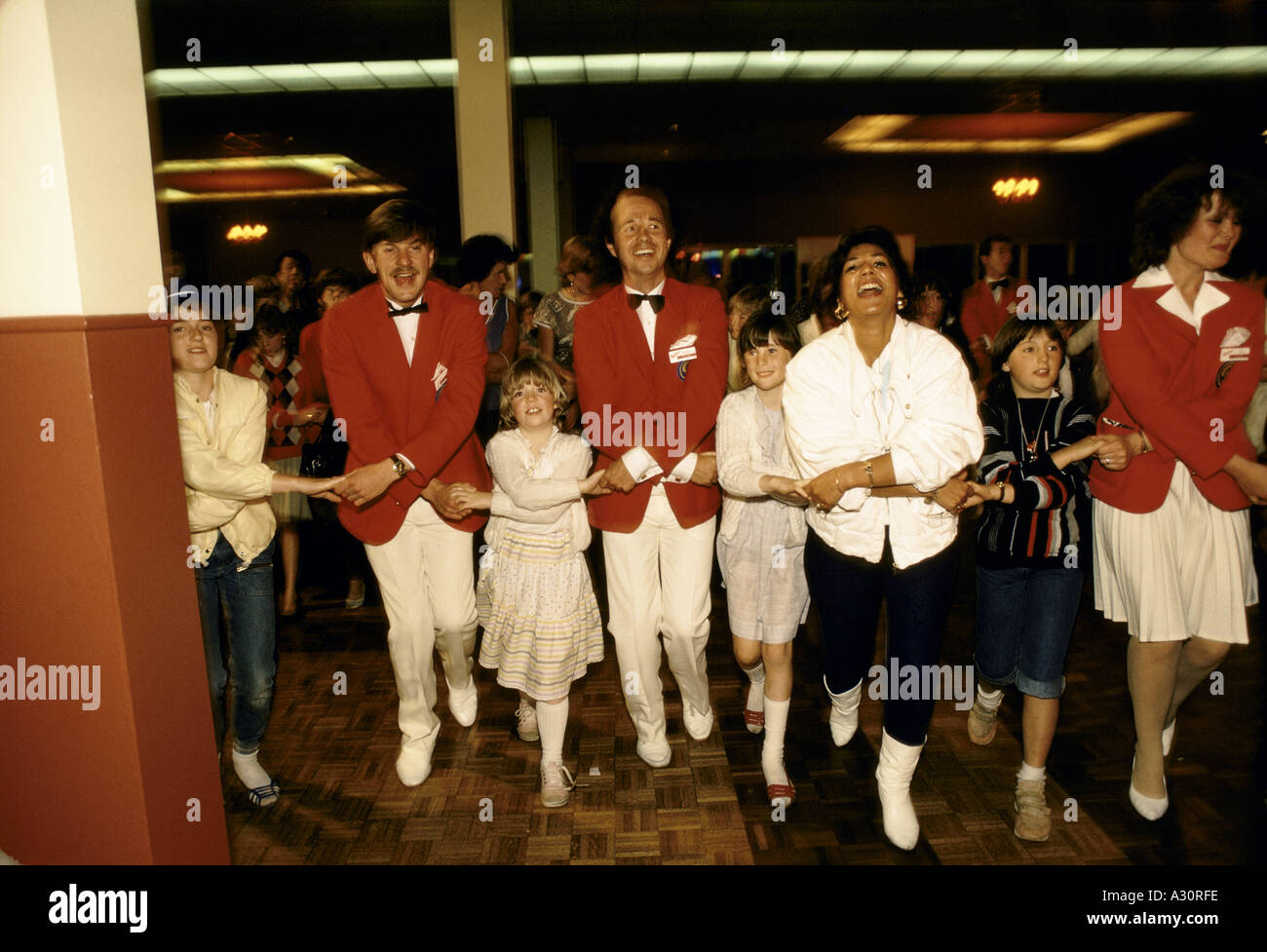 red coats with guests singing and dancing hand in hand at butlins Stock ...