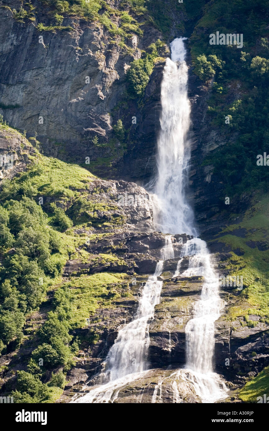 A waterfall flowing into the Geiranger Fjord Geirangerfjorden Norway ...
