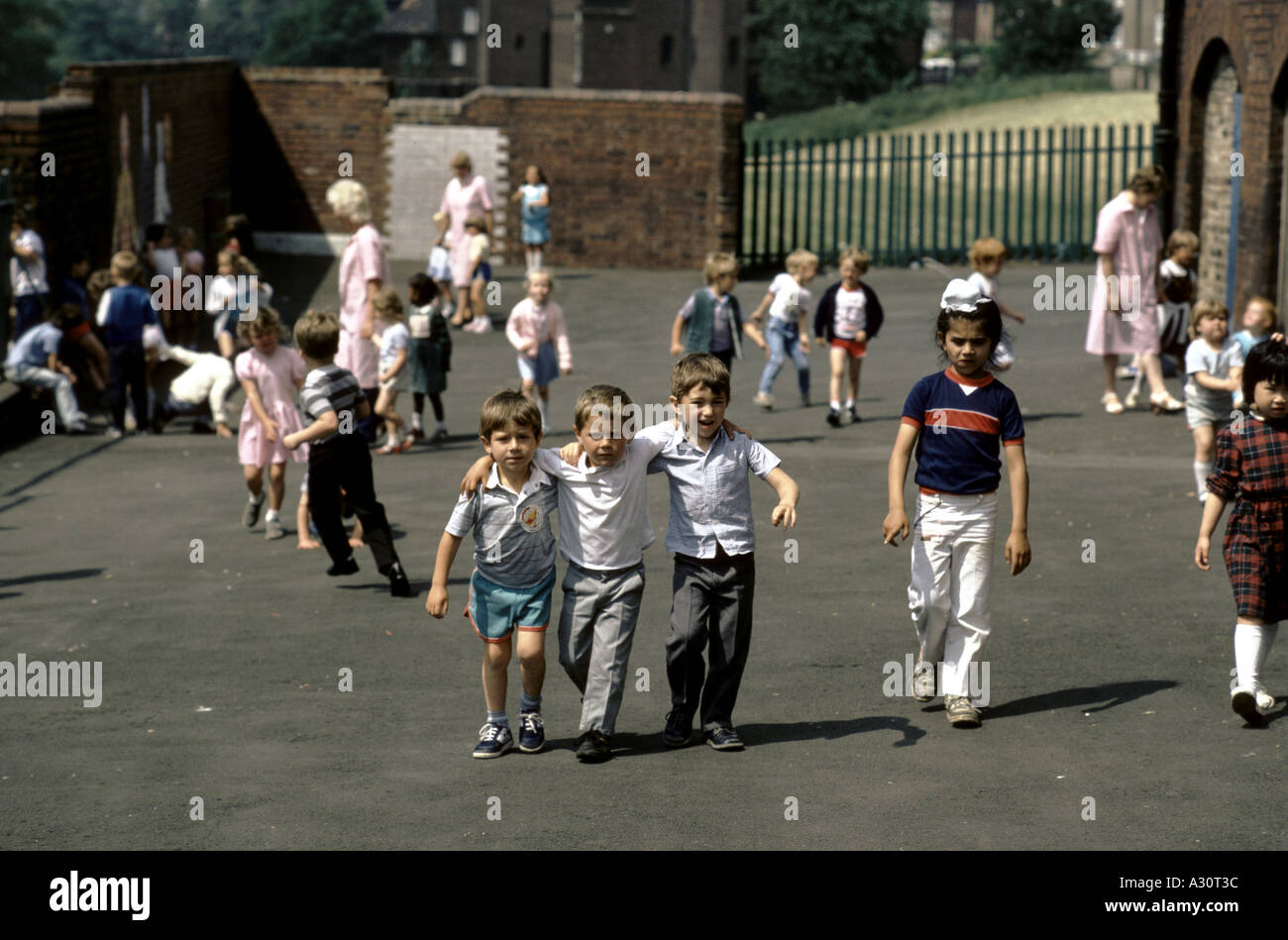 primary pupils of different ethnic group in a school playground Stock ...