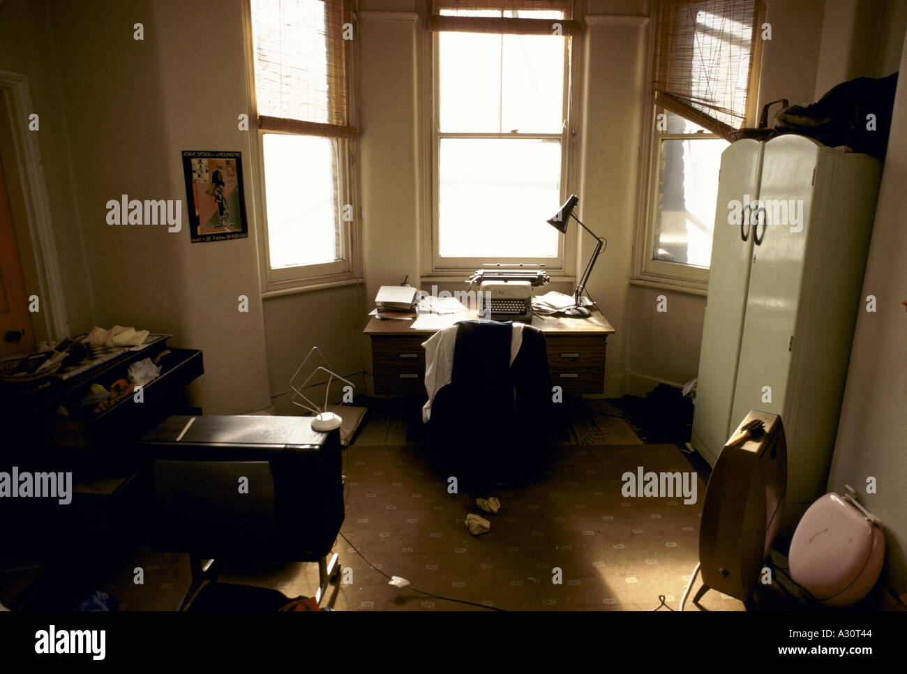 A desk in a disheveled room Stock Photo - Alamy