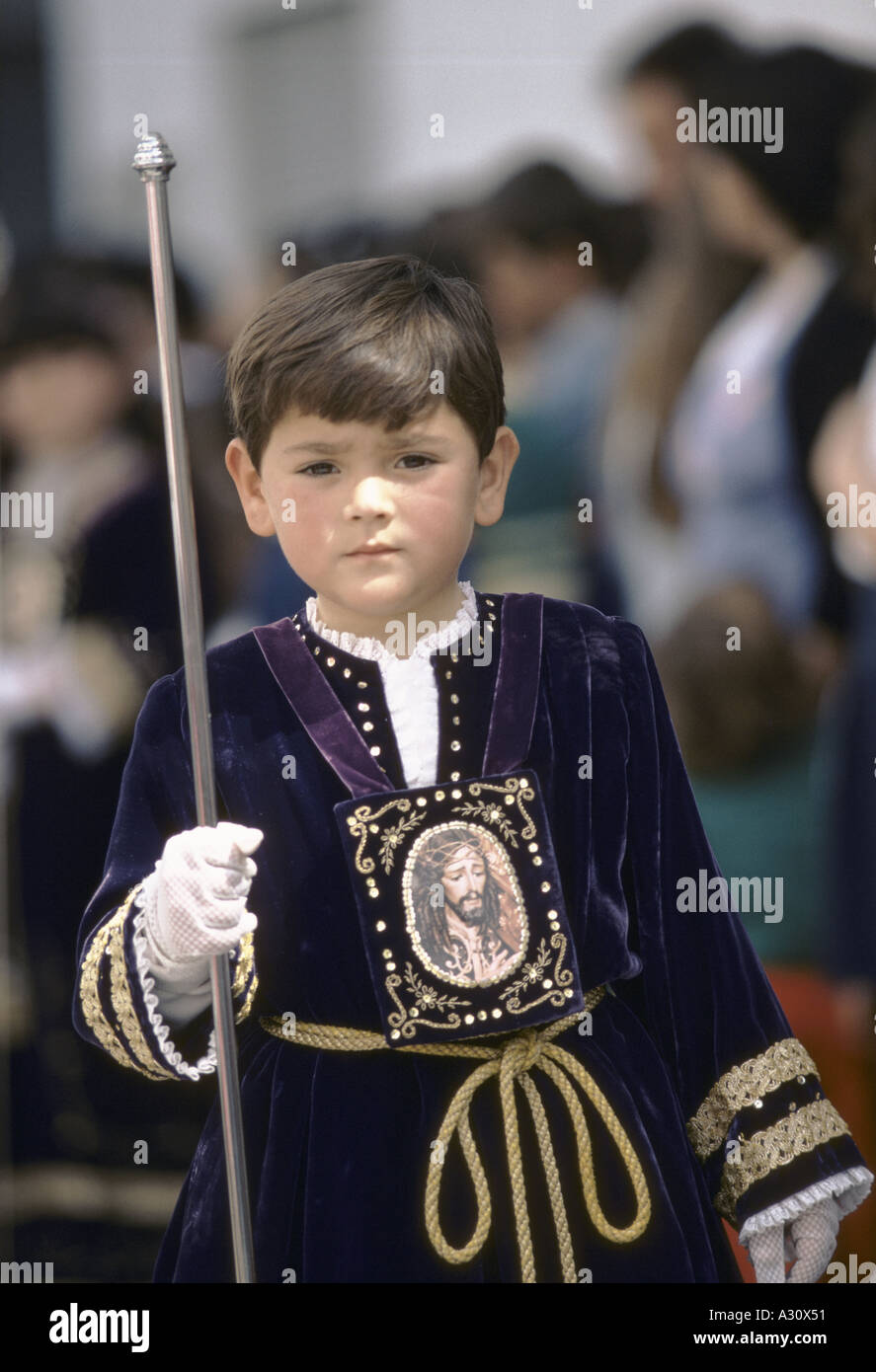 young boy carrying silver scepter wearing purple velvet frock coat with ...