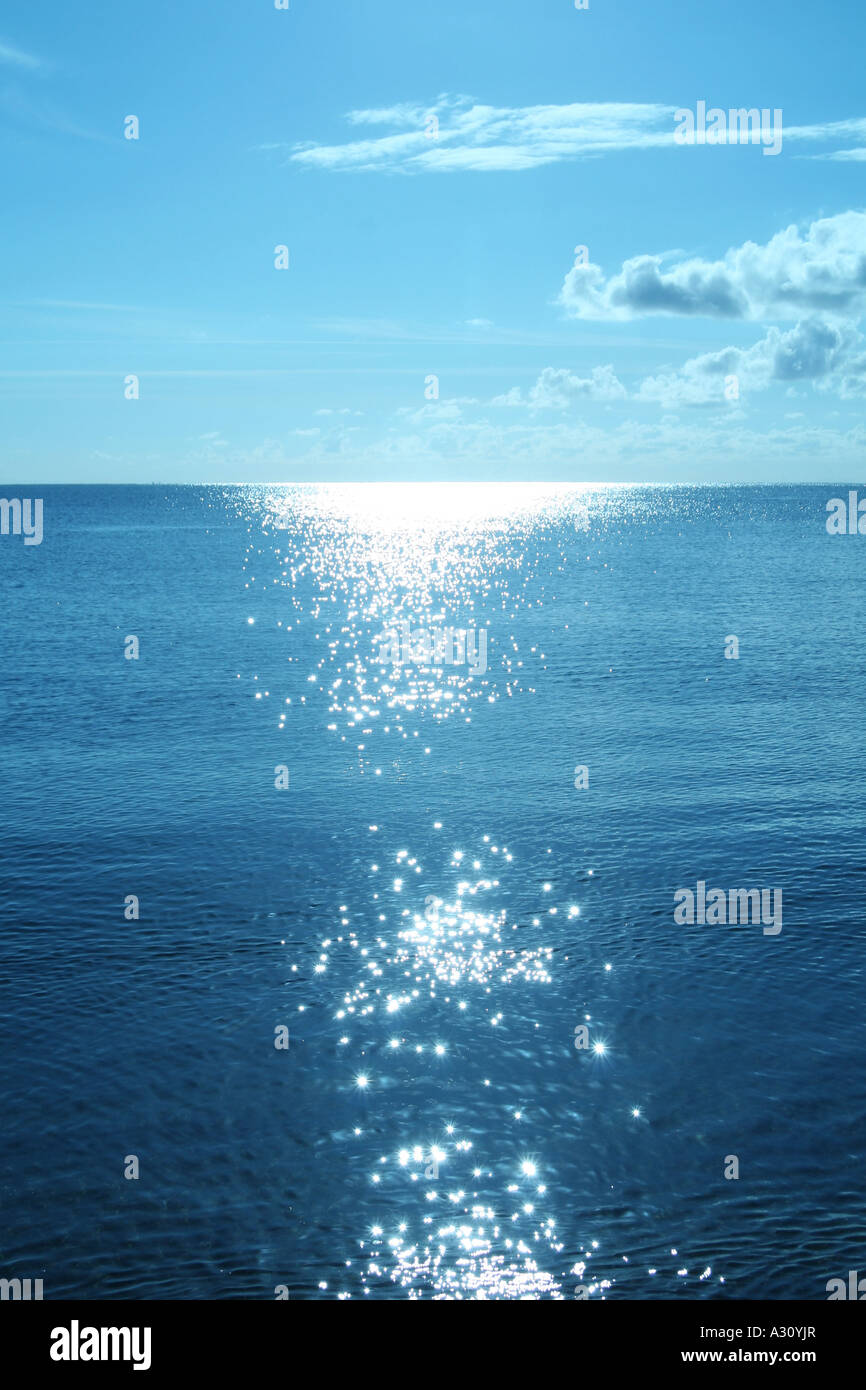 sunlight reflecting off a blue sea Stock Photo - Alamy