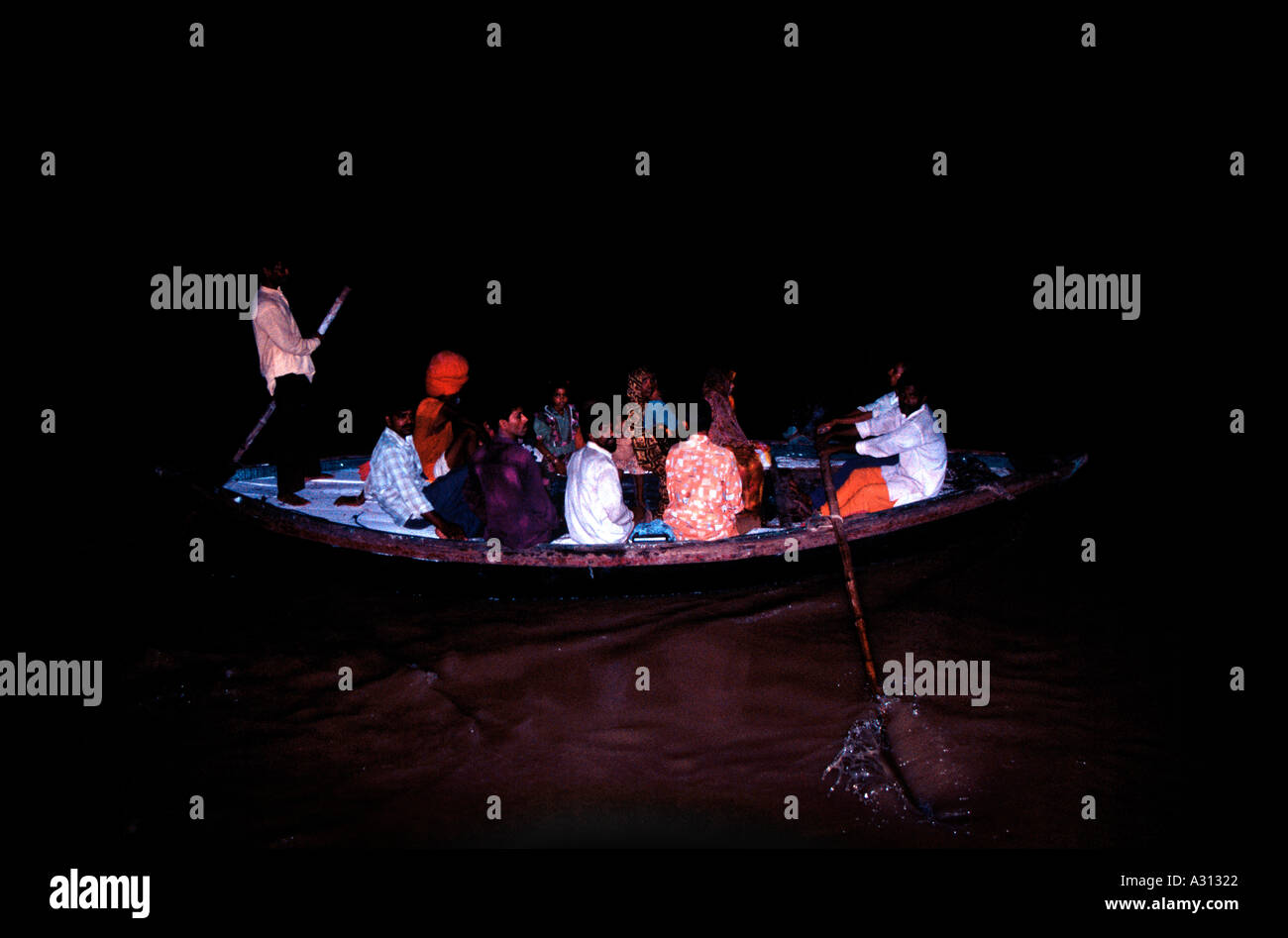 Indian people on rowboat on river Ganges at night Varanasi India Stock ...
