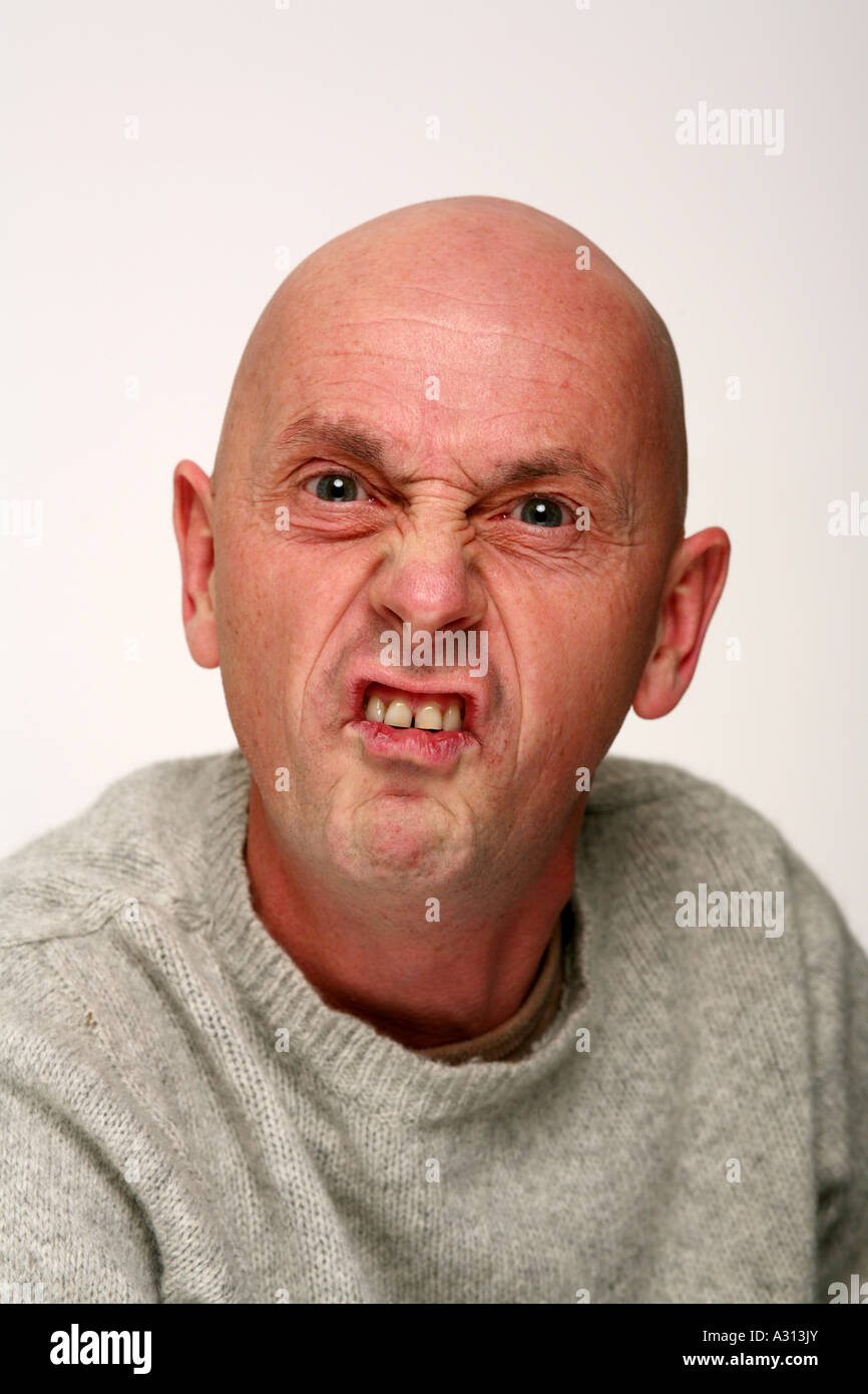 Studio shoot of angry bald man Stock Photo - Alamy