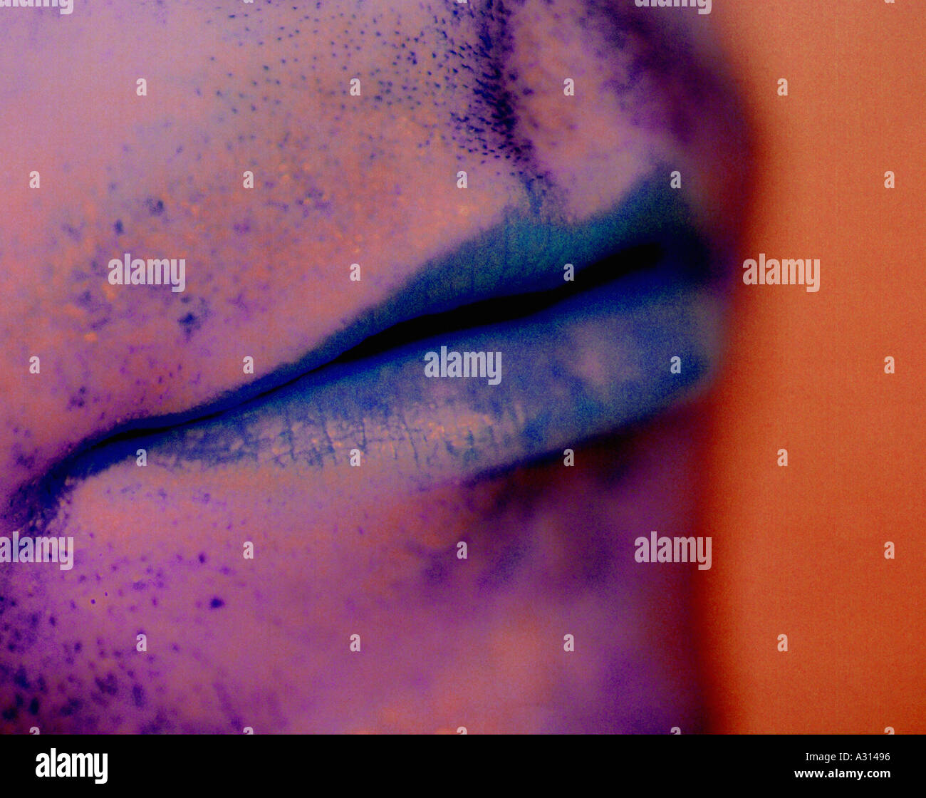 Blue lips on man's face orange bckground Stock Photo - Alamy