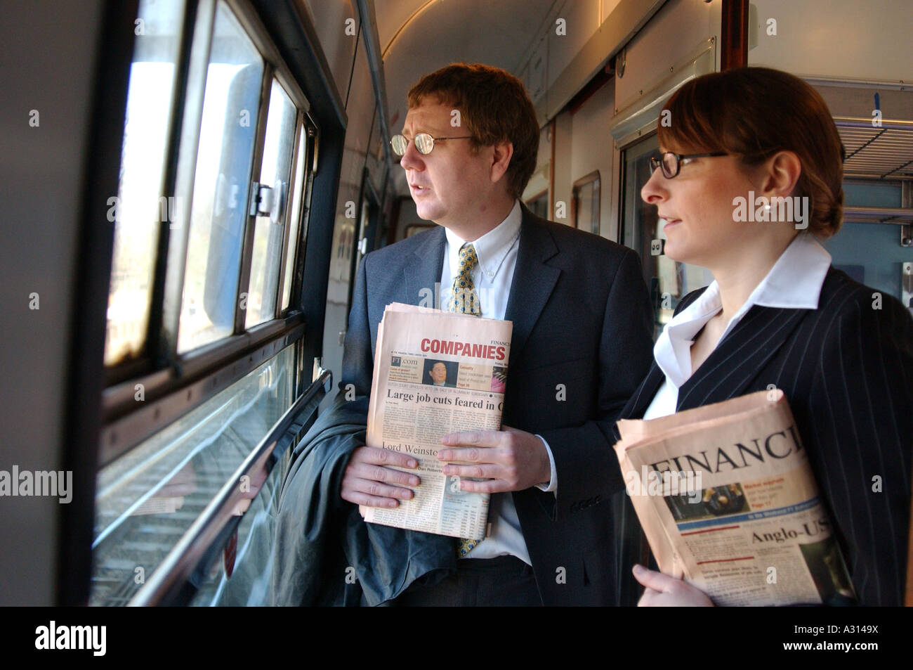 Photograph of British business man and woman traveling in first class ...