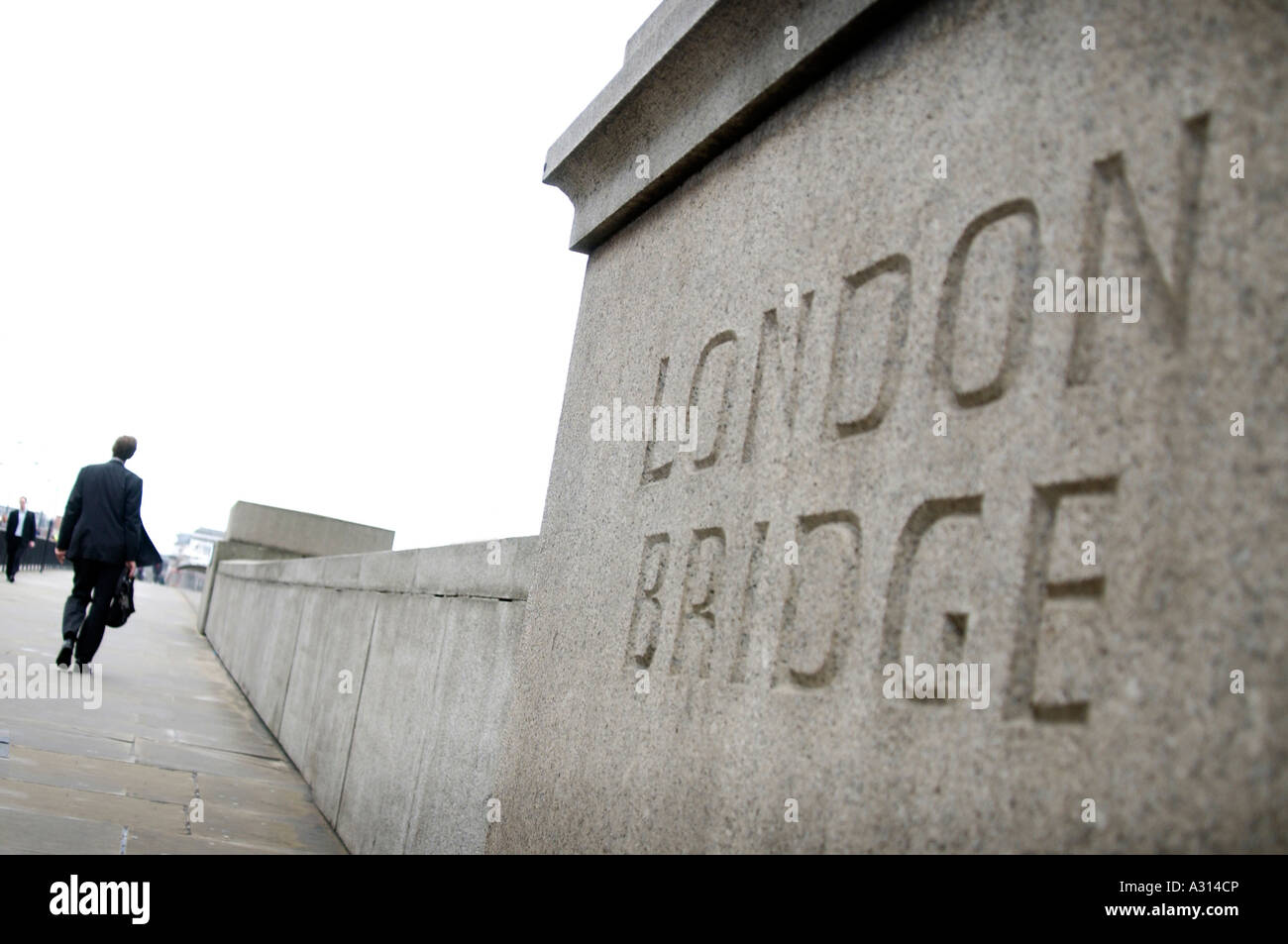 Royalty free photograph of Business man walking on London bridge in ...