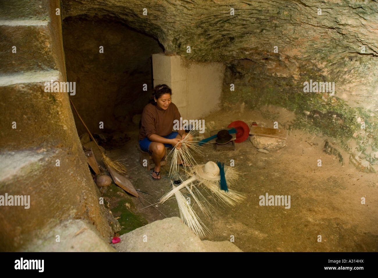 Woman braiding the famous panama straw hats in a traditional cave in ...
