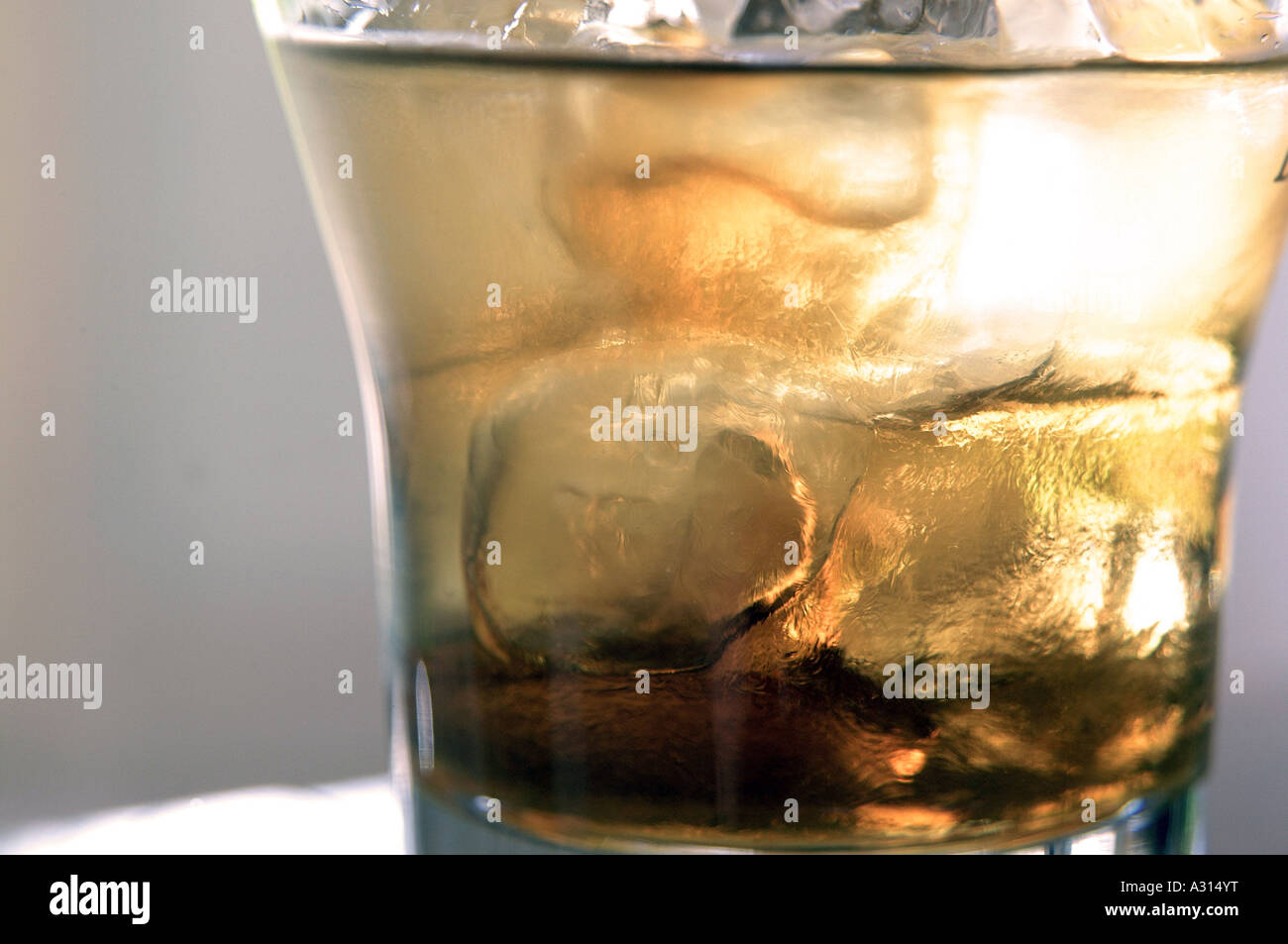 Royalty free photograph of whiskey glass with ice and backlight in a ...