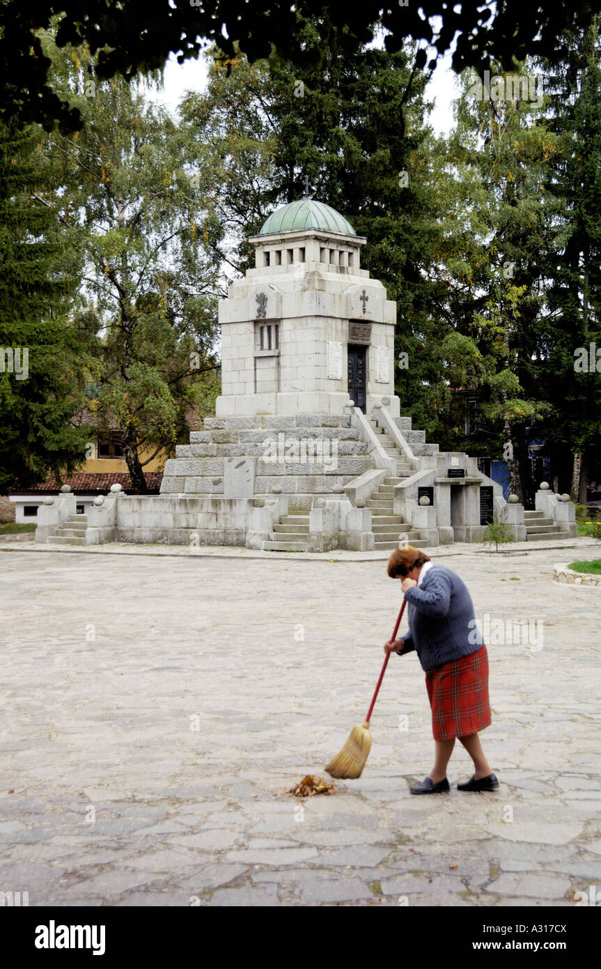 Lady sweeping near April uprising mausoleum Koprivshtitsa Bulgaria East ...