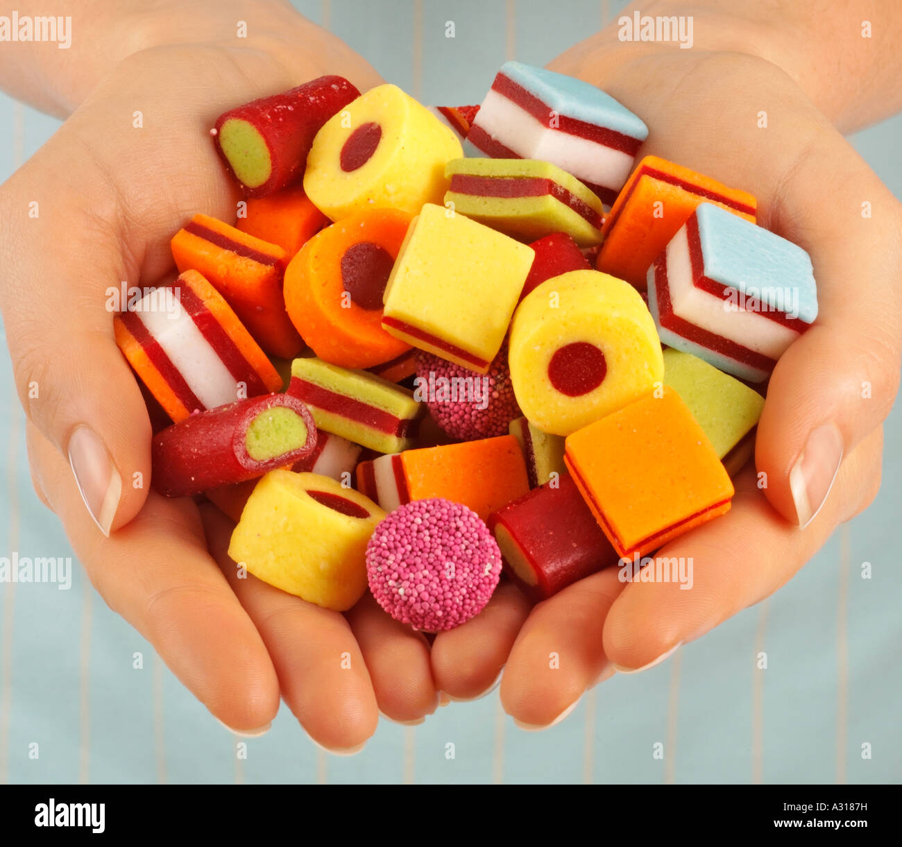 WOMAN HOLDING FRUIT ALLSORTS SWEETS / CANDIES Stock Photo - Alamy