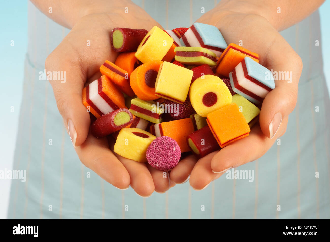 WOMAN HOLDING FRUIT ALLSORTS SWEETS / CANDIES Stock Photo - Alamy