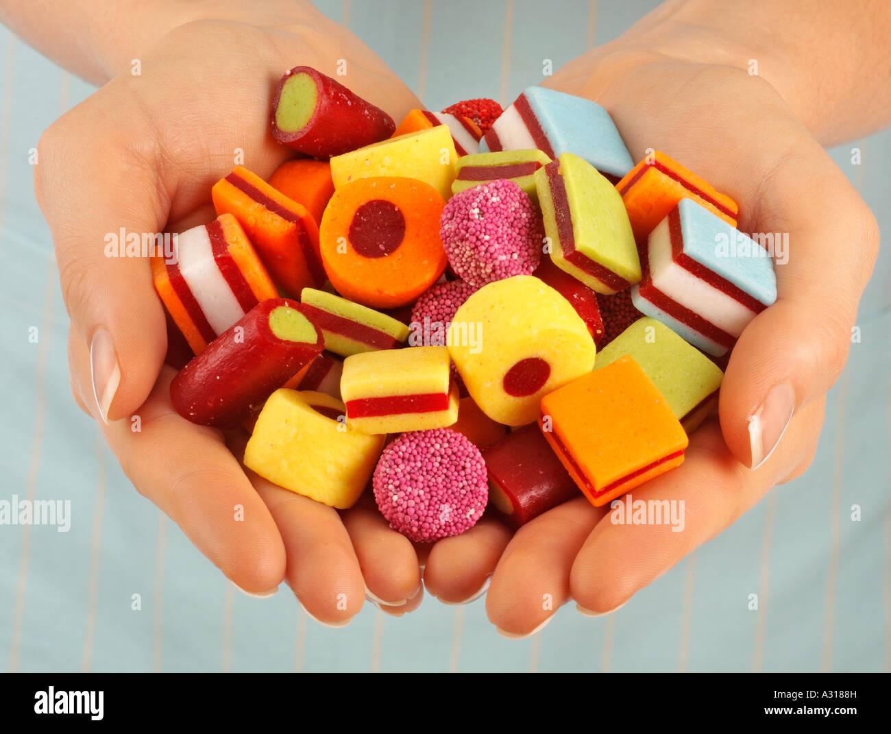 WOMAN HOLDING FRUIT ALLSORTS SWEETS / CANDIES Stock Photo - Alamy
