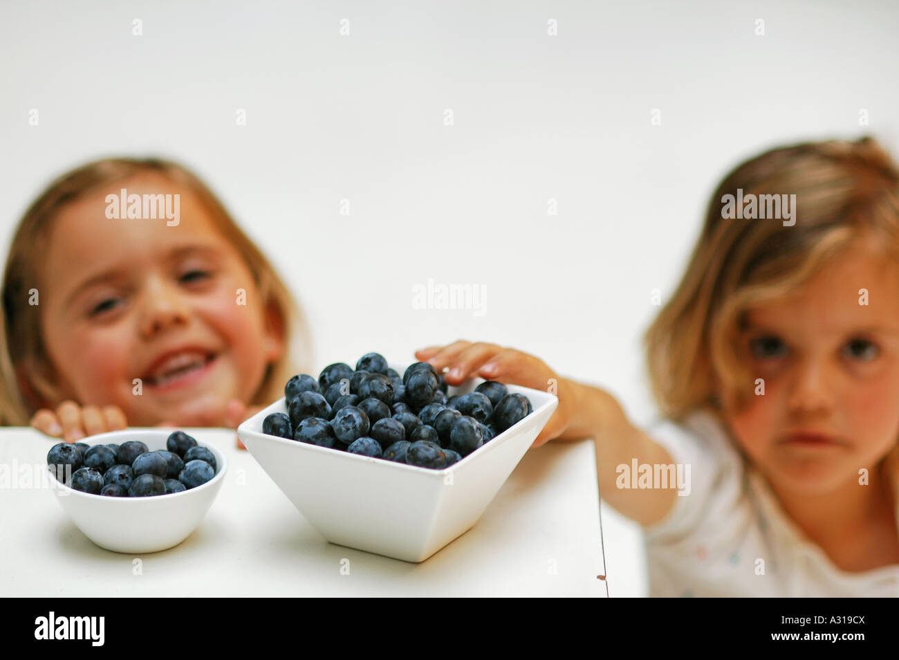 blond girls eating berries Stock Photo - Alamy
