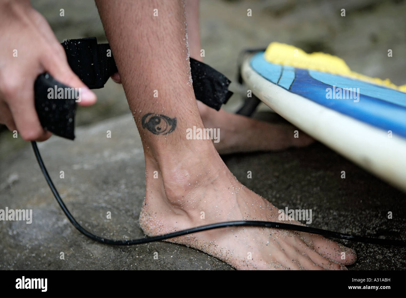 A man attaches a strap to his leg Stock Photo - Alamy