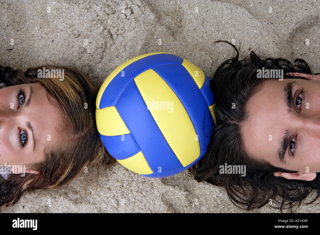 Close up of a ball placed in between two people Stock Photo - Alamy