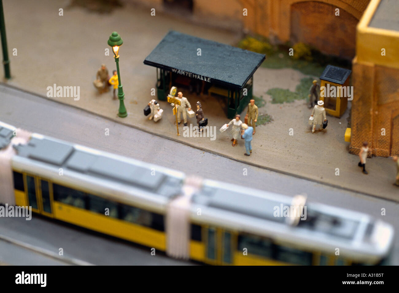 Model of commuters waiting at tram stop Stock Photo - Alamy
